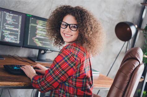 Young Female Programmer Working From Home In A Casual Checkered Shirt