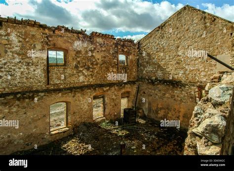 The Angular View Shows Crumbling Stone And Brick Walls In A Derelict