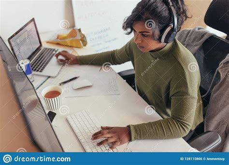 Female Programmer Coding On Computer Female Programmer Coding On A Desktop Comp Sponsored