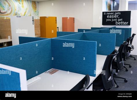 Empty Modern Office Space With Row Of Desks Separated By Desk Dividers