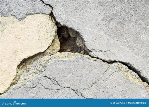 Big Deep Branched Crack On Multicolored Wall With Remnants Of Old
