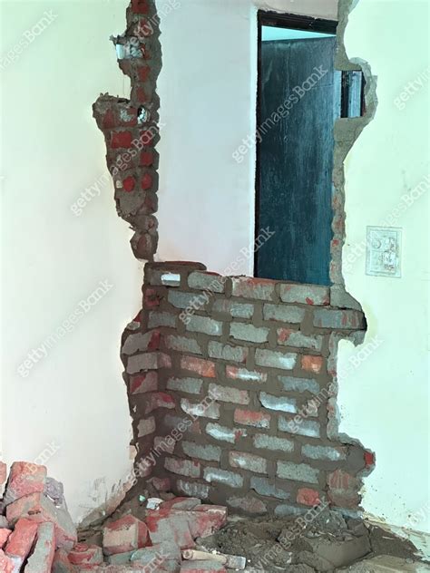 Image Of House Builder Sealing Doorway With Bricks Home Renovation