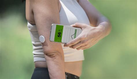 Diabetic Woman Monitoring And Checking Glucose Level With A Remote Sensor And A New Technology