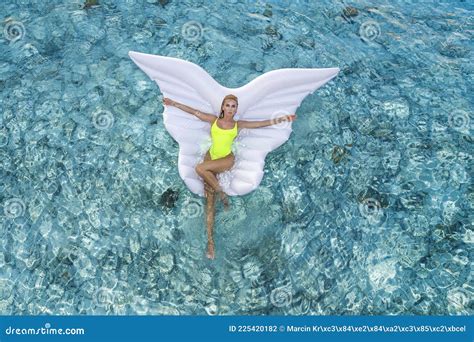 Beautiful Tanned Woman Bikini Model On Butterfly Shaped Mattress In