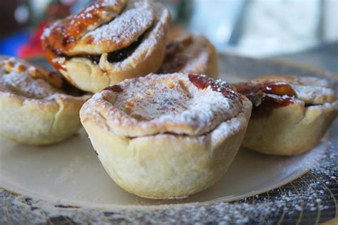 배경에서 크리스마스 트리와 함께 만든 다진 파이의 이미지 흐린 요정 조명 케이크를 통해 가루 설탕 가루 다진 파이 조리법 미니 고기 혼합물을 표시 하 고 짧은 빵 과자 접시