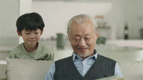 Asian Grandpa And Grandson Chatting Talking Reading Book Together Stock Video Video Of Five