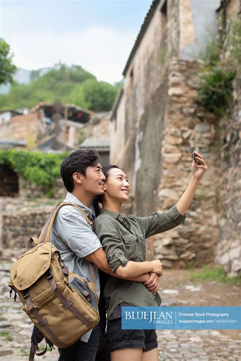 Young Chinese Couple Taking Selfie With Smartphone In Village High Res