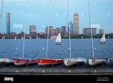 Small Sailboats Are Moored On A Dock Across The Charles River With A
