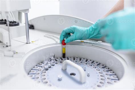 Hands Of Female Researcher Loading Samples In Centrifuge In Laboratory Stock Photo At