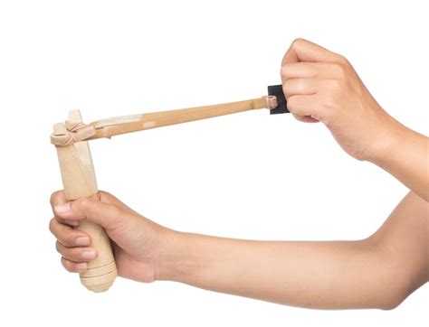 손을 당기는 흰색 배경에 고립 된 투석기 새총 프리미엄 사진