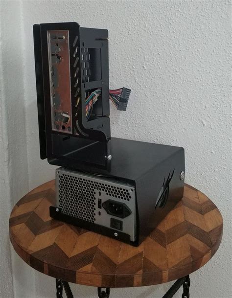A Computer Sitting On Top Of A Wooden Table