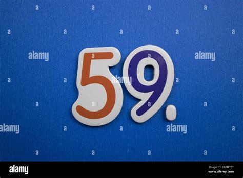 The Number 59 Placed On A Blue Background Photographed From Above