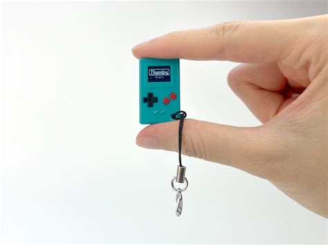 Thumby™ The Playable And Programmable Keychain Teal Oz Robotics