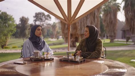 Two Saudi Arab Gulf Women Sitting In One Of The Public Parks In The