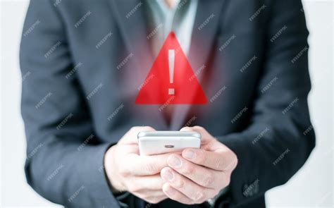 Premium Photo Businessman Using A Smartphone With A Warning Sign System Error Hologram Data