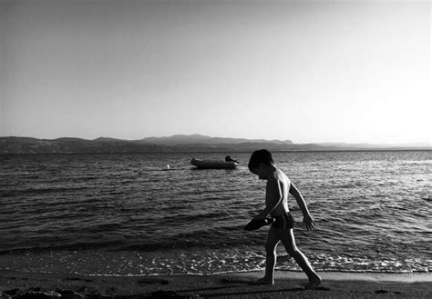 Premium Photo Shirtless Boy Walking At Beach