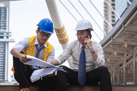 Engineer Man Team With Drawing Paper Planning Projects In Construction