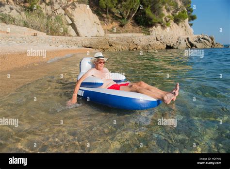 Senior Man On Vacation Floating On Chair In The Sea Stock Photo Alamy