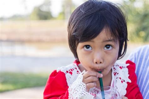 Premium Photo Cute Girl Drinking Outdoors