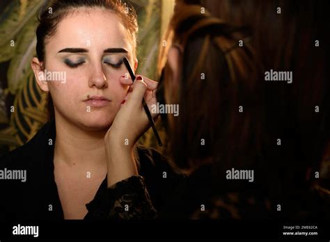 Professional Make Up Artist Applying Makeup To A Beautiful Model Stock