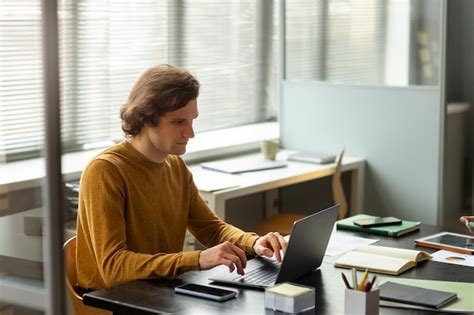 Free Photo Side View Man Working On Laptop
