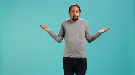 Man Shrugging Shoulders Not Caring Having Detached Apathy Facial
