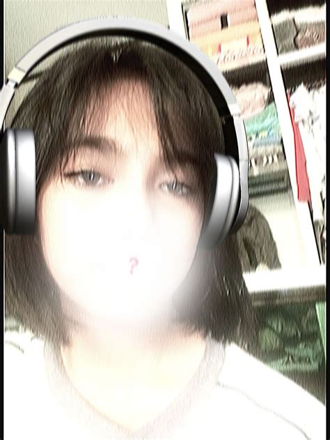 A Babe Man Wearing Headphones And Listening To Music