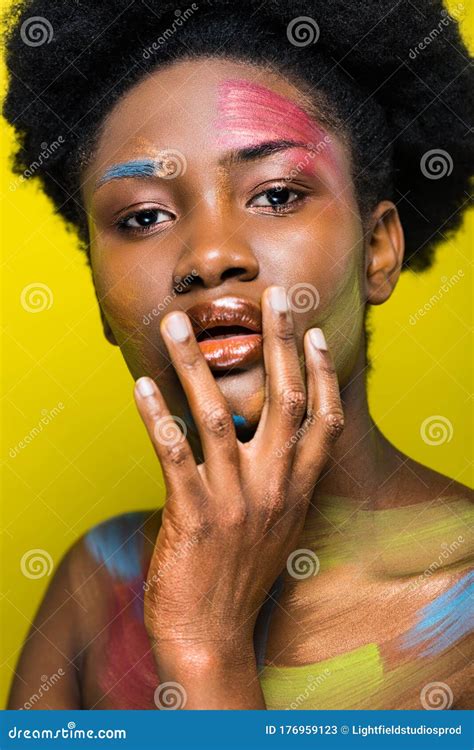 African American Woman With Body Art Touching Lips And Looking At