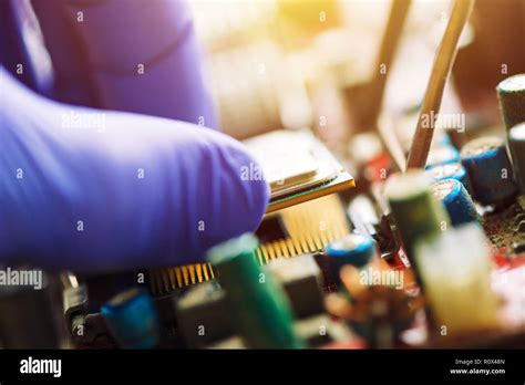 Computer Forensics Investigator Installing Old Cpu On Computer Motherboard To Recover Machine
