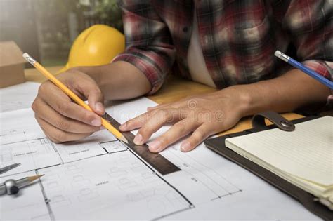 Architect Measuring Scale On Blueprint In Construction Site Stock Image