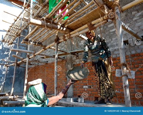 Asian Female Labour Giving Raw Material Pot To The Worker On Construction Site In India January
