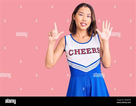 Young Beautiful Chinese Girl Wearing Cheerleader Uniform Showing And