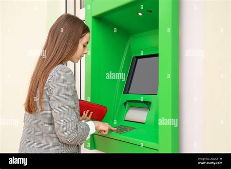 Woman Withdrawing Money From ATM Stock Photo Alamy