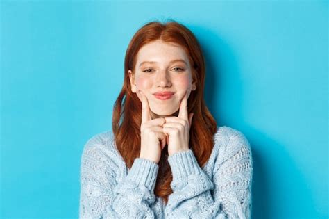 Free Photo Closeup Of Cute And Silly Girl With Red Hair Poking Cheeks