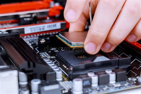 The Process Of Installing In CPU Microprocessor To Motherboard Socket Stock Photo Image Of