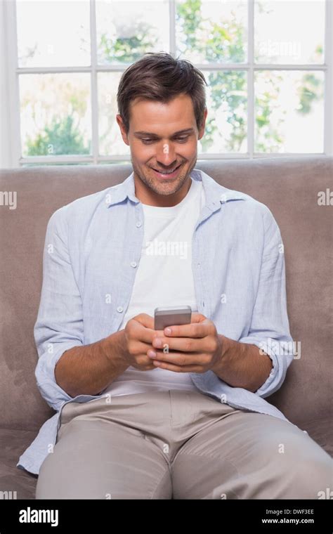 Casual Man Reading Text Message On Sofa Stock Photo Alamy