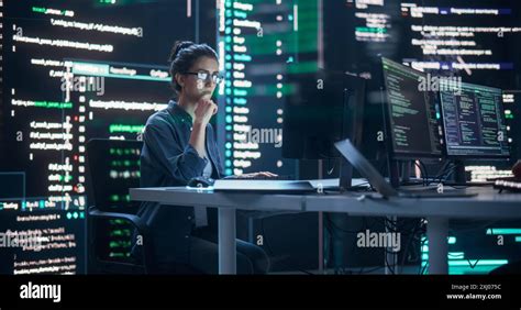 Focused Woman Working On A Computer Typing Lines Of Code That Appear