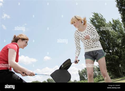Girls Playing With Rackets In Park Stock Photo Alamy