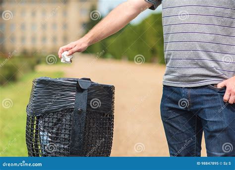 Man Hand Throw A Plastic Bottle Into Recycle Dustbin Garbage Sorting Before Putting In Garbage