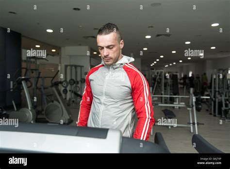 Handsome Man Running On The Treadmill In Gym Stock Photo Alamy