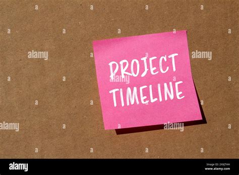 Project Timeline Message Written On Pink Paper With Cardboard Background Conceptual Project