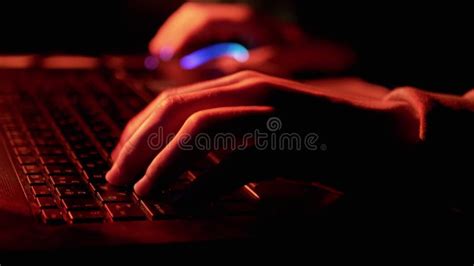 Close Up Hands Of A Male Typing On A Keyboard In A Dark Room With Neon Lighting Stock Footage