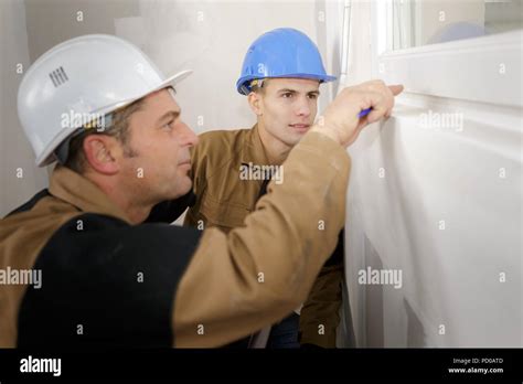 Construction Workers Installing Window In House Stock Photo Alamy