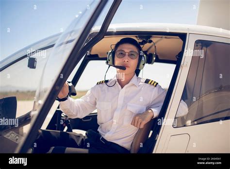 Chinese pilot sitting in helicopter cockpit Stock Photo - Alamy