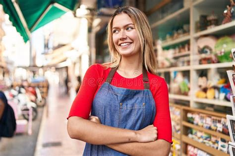 Young Hispanic Woman Shop Assistant Standing With Arms Crossed Gesture