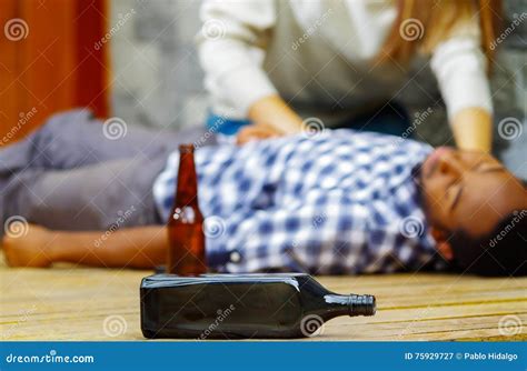 Man Wearing Casual Clothes Lying Drunk Passed Out On Wooden Surface
