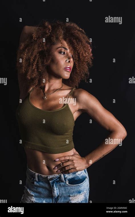 Curly Haired African American Female In Trendy Crop Top And Jeans
