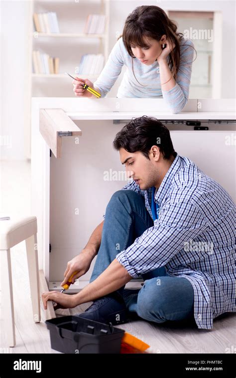 Husband Repairing Broken Table At Home Stock Photo Alamy