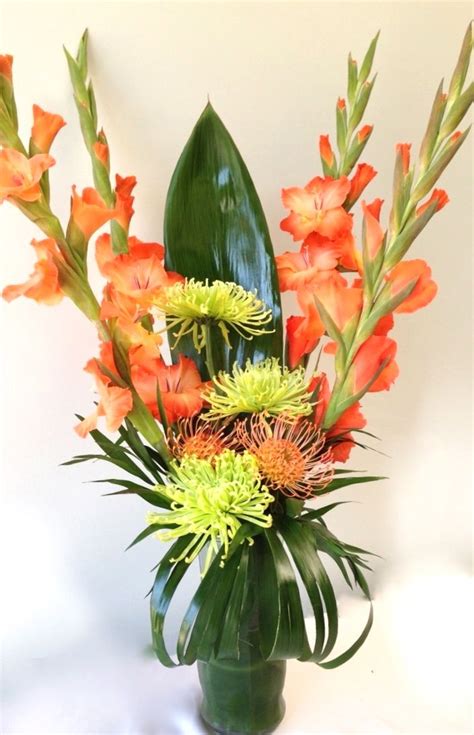 Tropical Arrangement Orange Gladiolas Green Spider Mums And Ti Leaves
