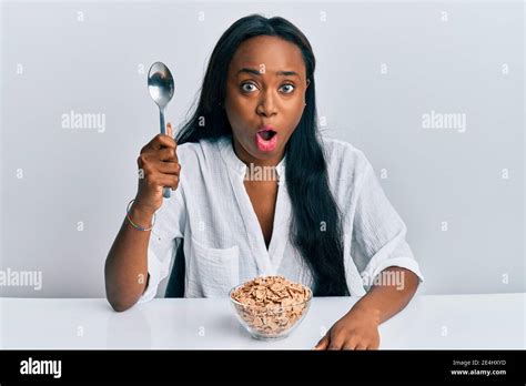 Young African Woman Eating Healthy Whole Grain Celears Scared And